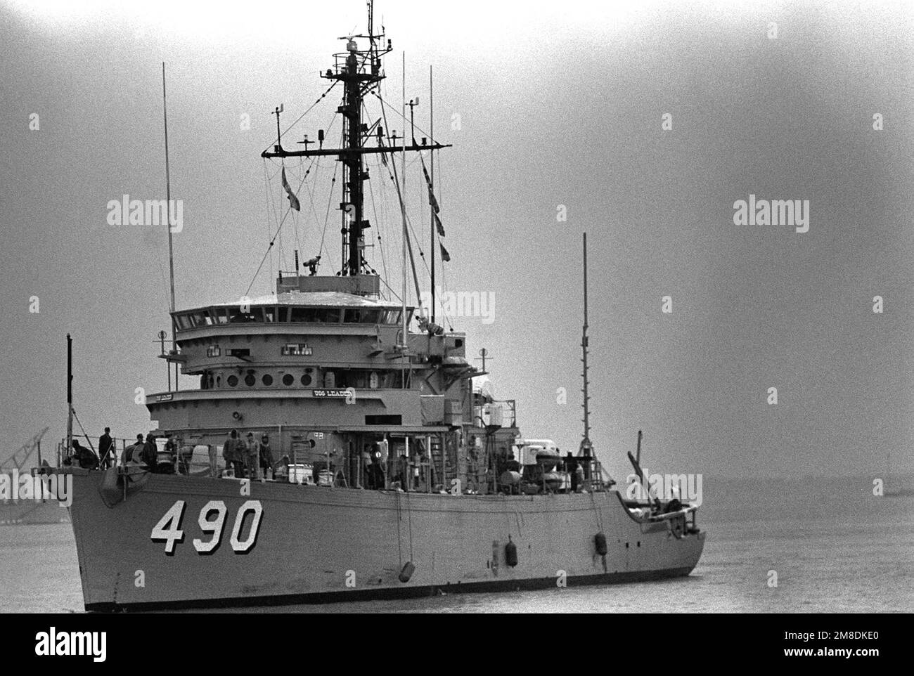 The ocean minesweeper USS LEADER (MSO-490) waits in the harbor prior to ...