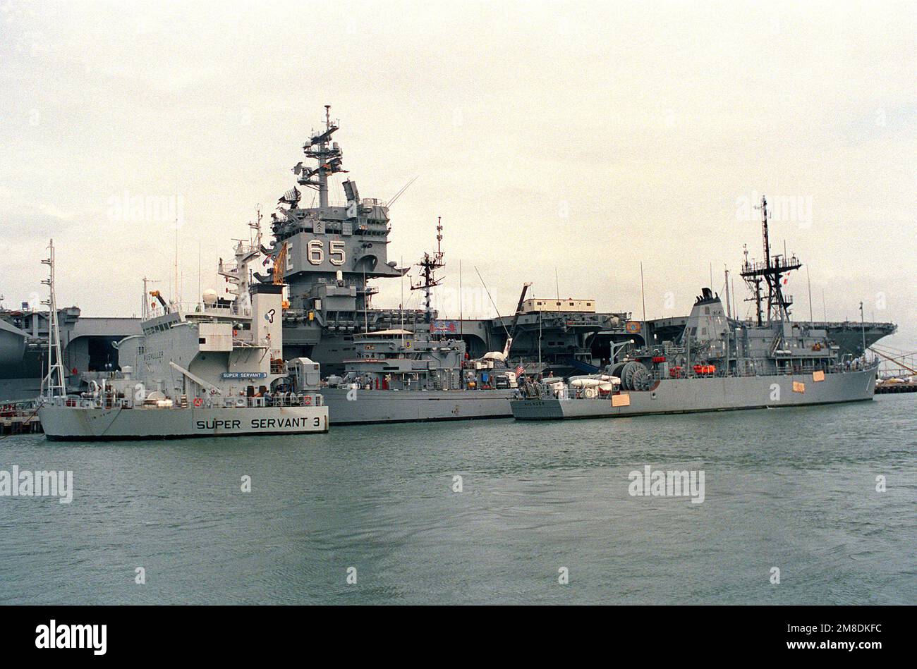 The mine countermeasures ship USS AVENGER (MCM-1), right, is pulled ...
