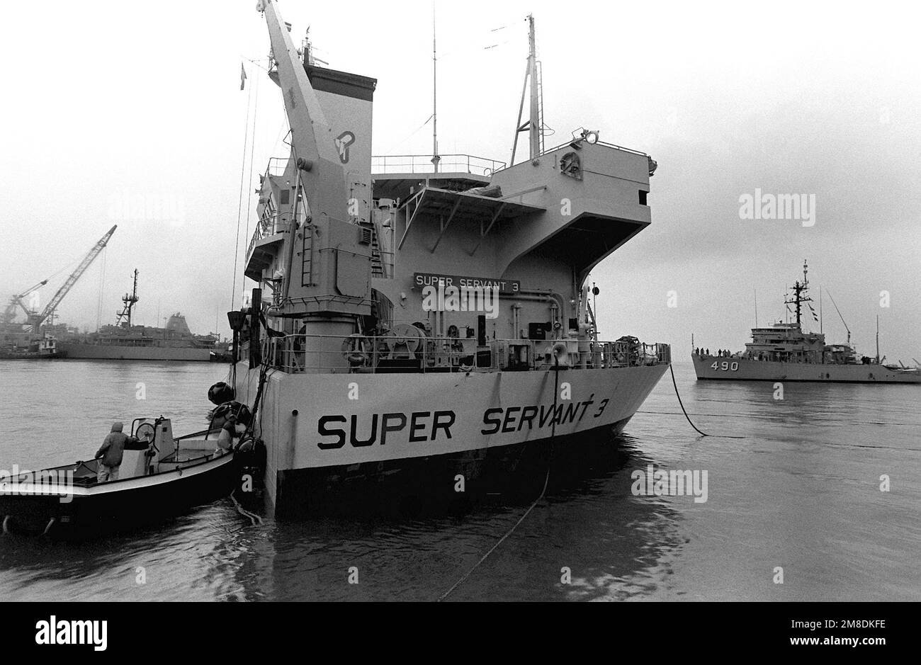 A work boat moves alongside the superstructure of the Dutch heavy lift ...