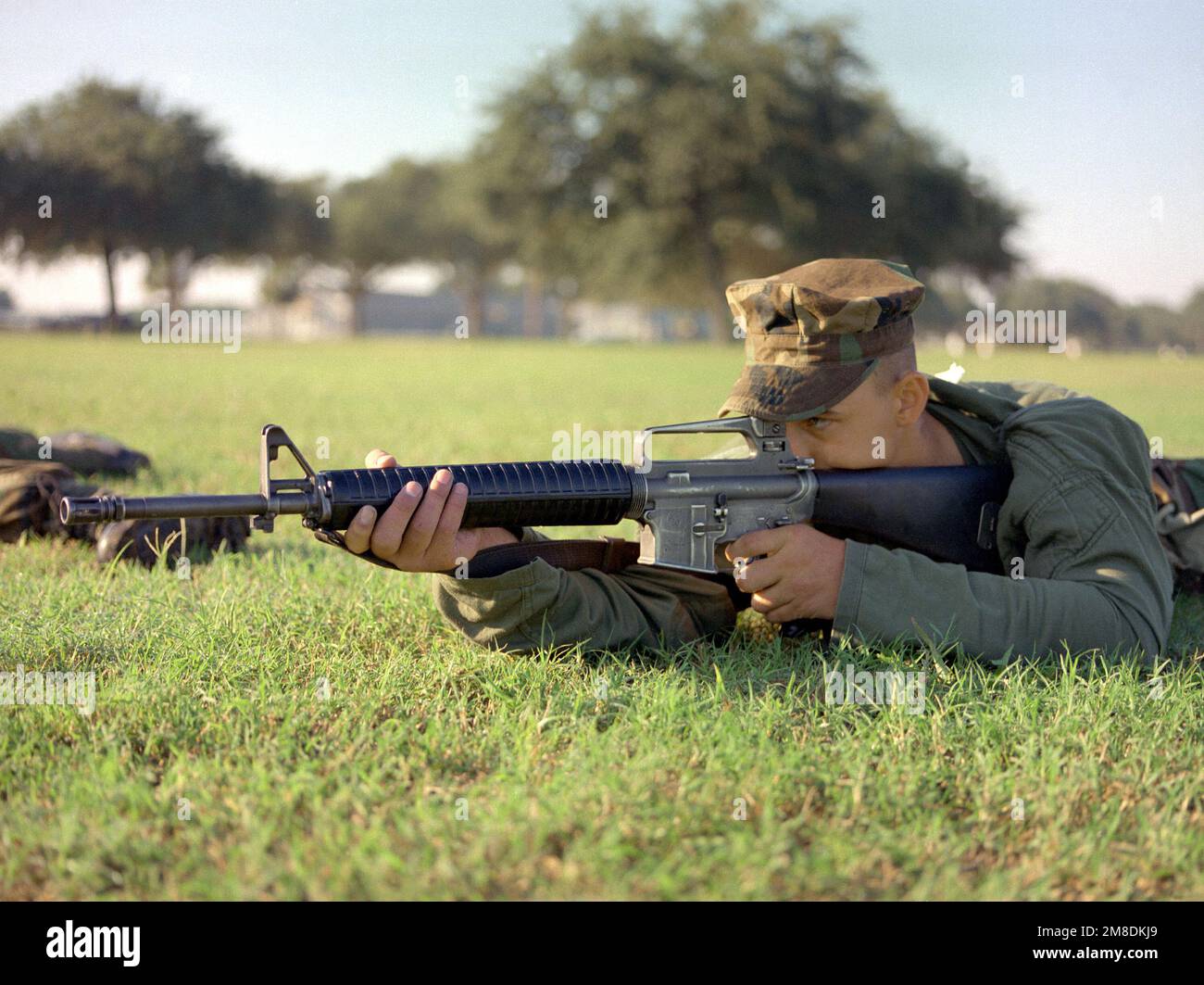 A 1ST Battalion recruit aims his M-16A2 rifle from the prone position ...