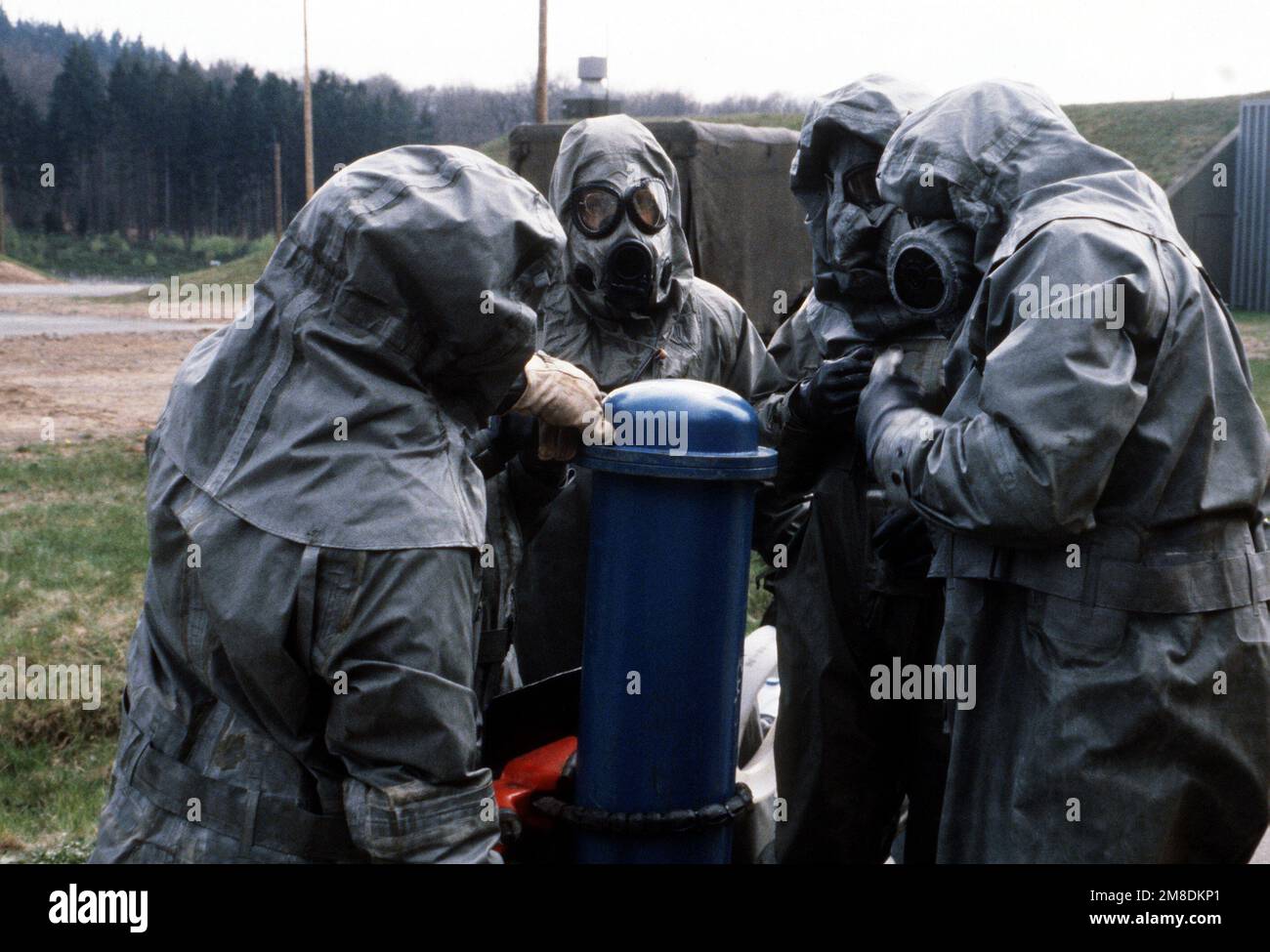 Chemical reaction team personnel wearing nuclear-biological-chemical ...