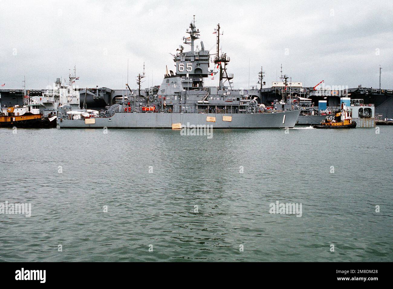 Commercial harbor tugs position the mine countermeasures ship USS ...