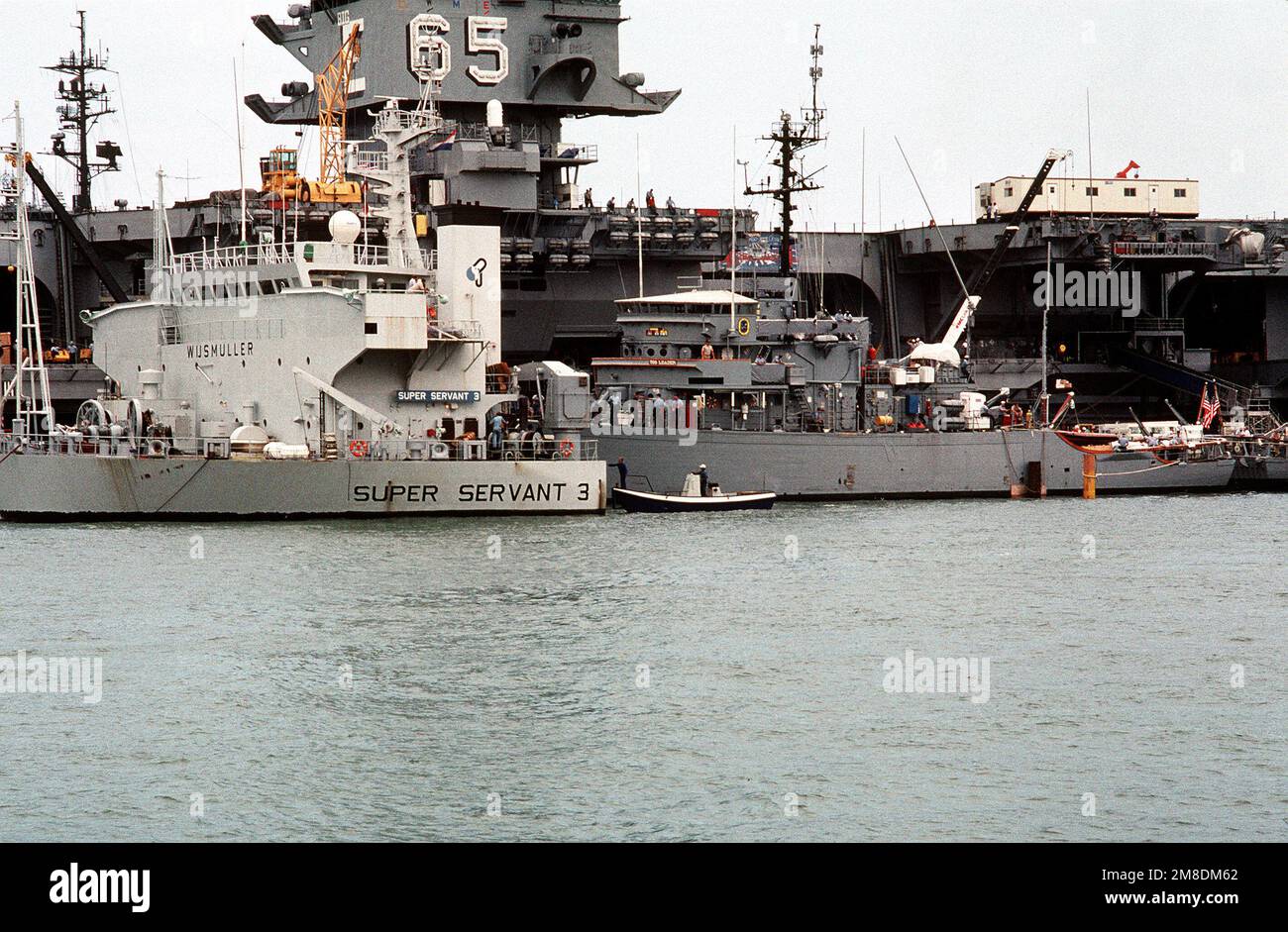 The ocean minesweeper USS LEADER (MSO-490) is moored to the submerged ...