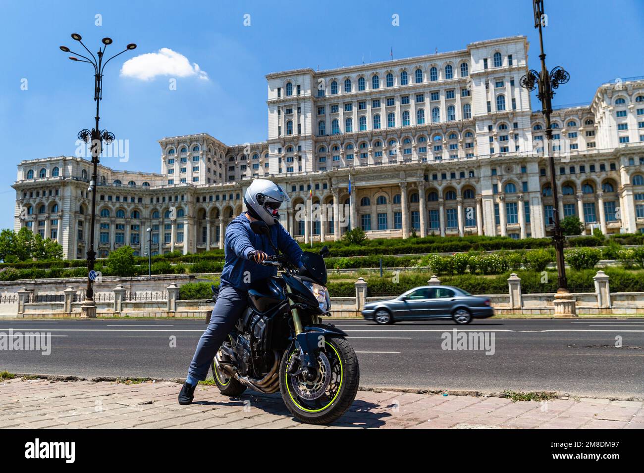 Biker on a motorcycle in traffic at rush hour in downtown area of the ...