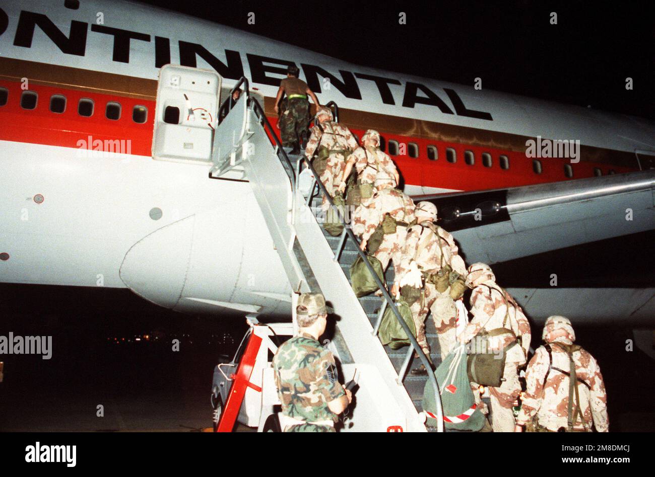 Soldiers from the 24th Infantry Division (Mechanized) board a chartered ...