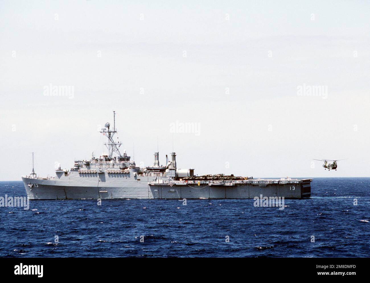 A Marine Corps CH-46E Sea Knight helicopter approaches the flight deck ...