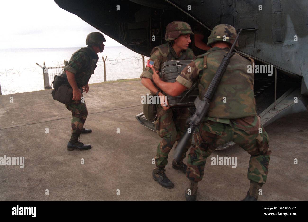 Marines at the U.S. Embassy unload a container of hot food from a CH ...