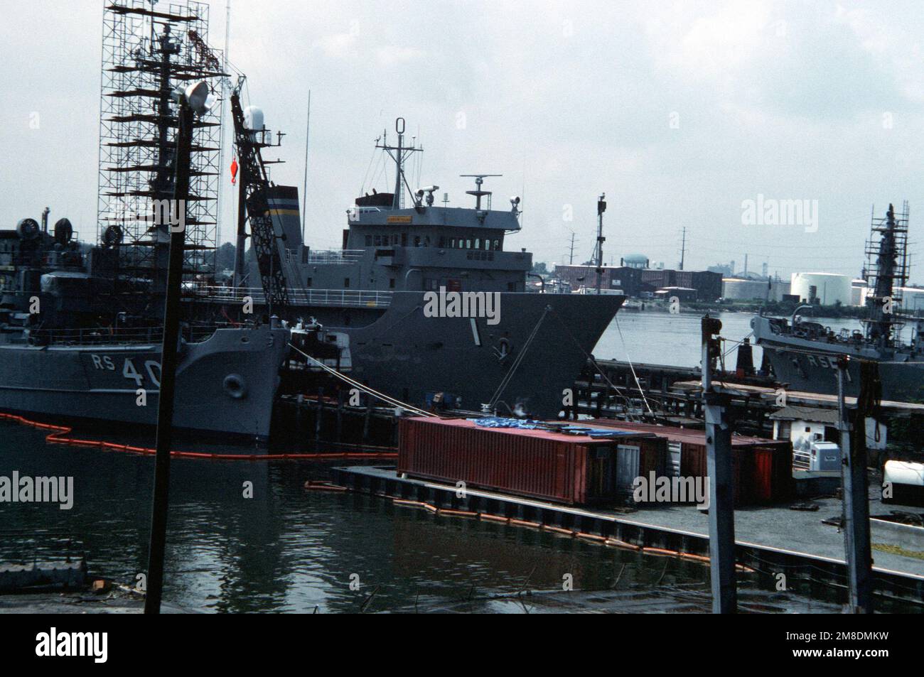 The ocean surveillance ship USNS STALWART (T-AGOS-1), center, lies tied ...