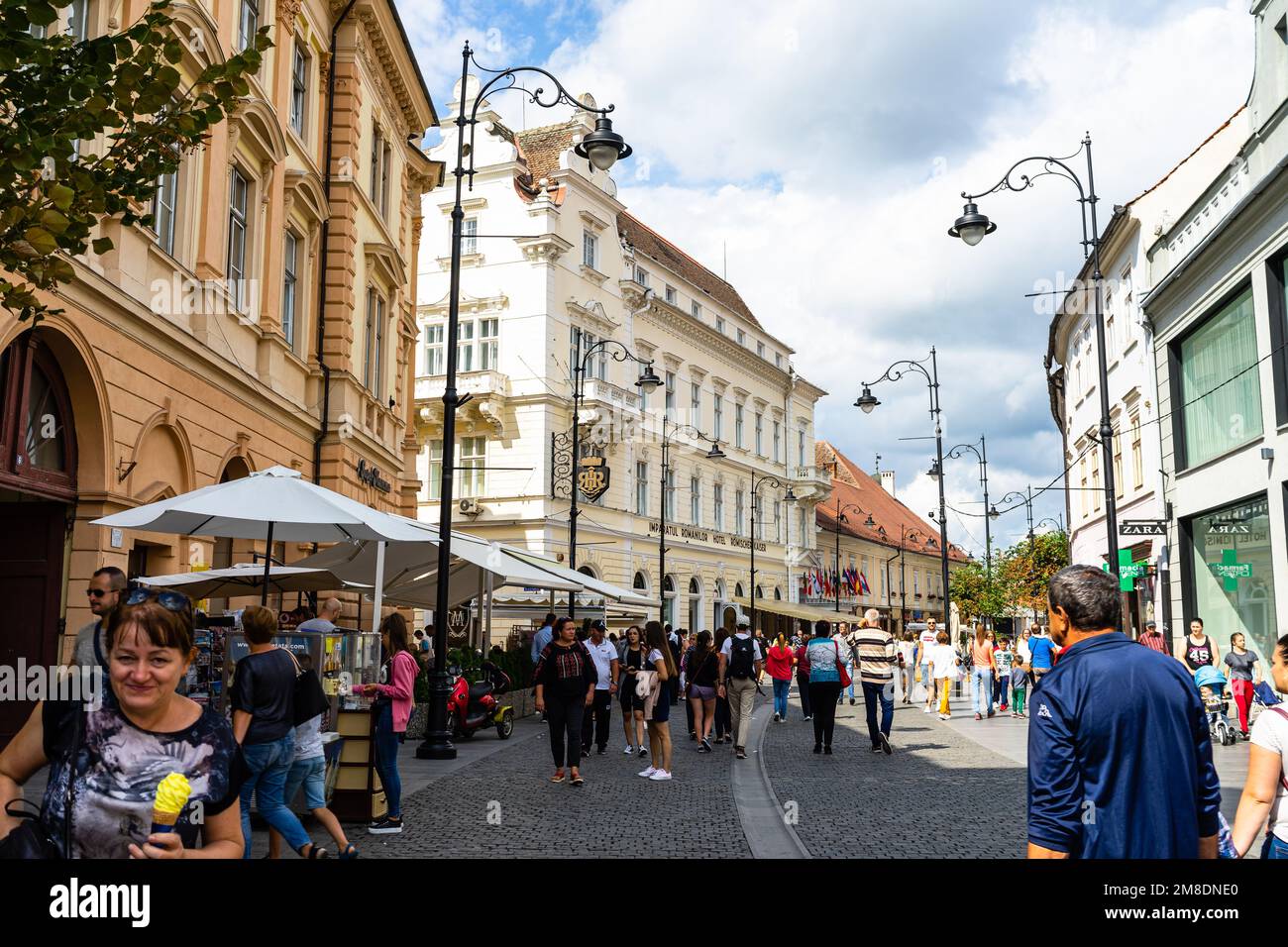 People and tourists wandering on the streets of old town Sibiu, Romania ...