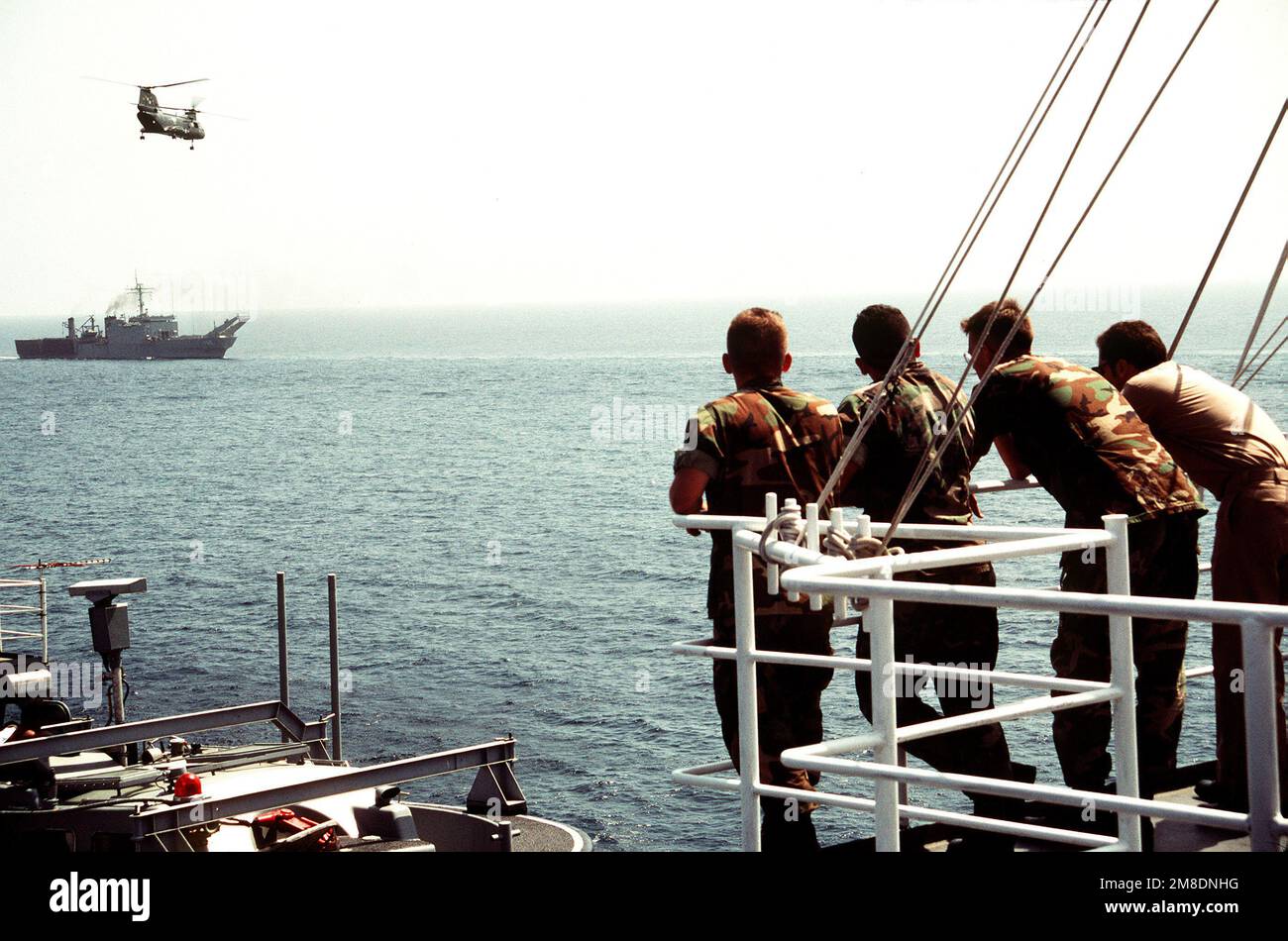 Marines aboard the amphibious transport dock USS DUBUQUE (LPD-8) watch ...