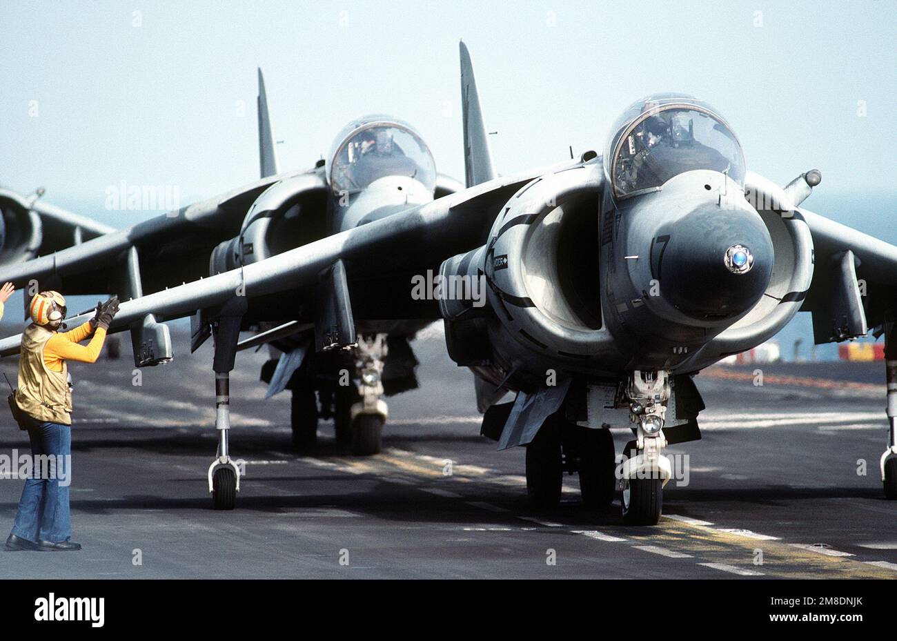 Two Marine Corps AV-8B Harrier aircraft are given final preflight ...
