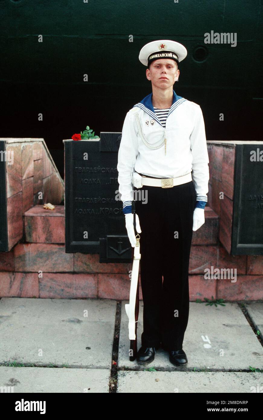 A Soviet sailor stands at attention before a war memorial during a ...