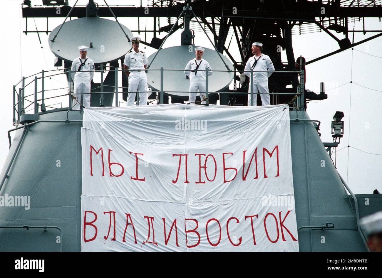 Crew members man the rails aboard the guided missile cruiser USS ...