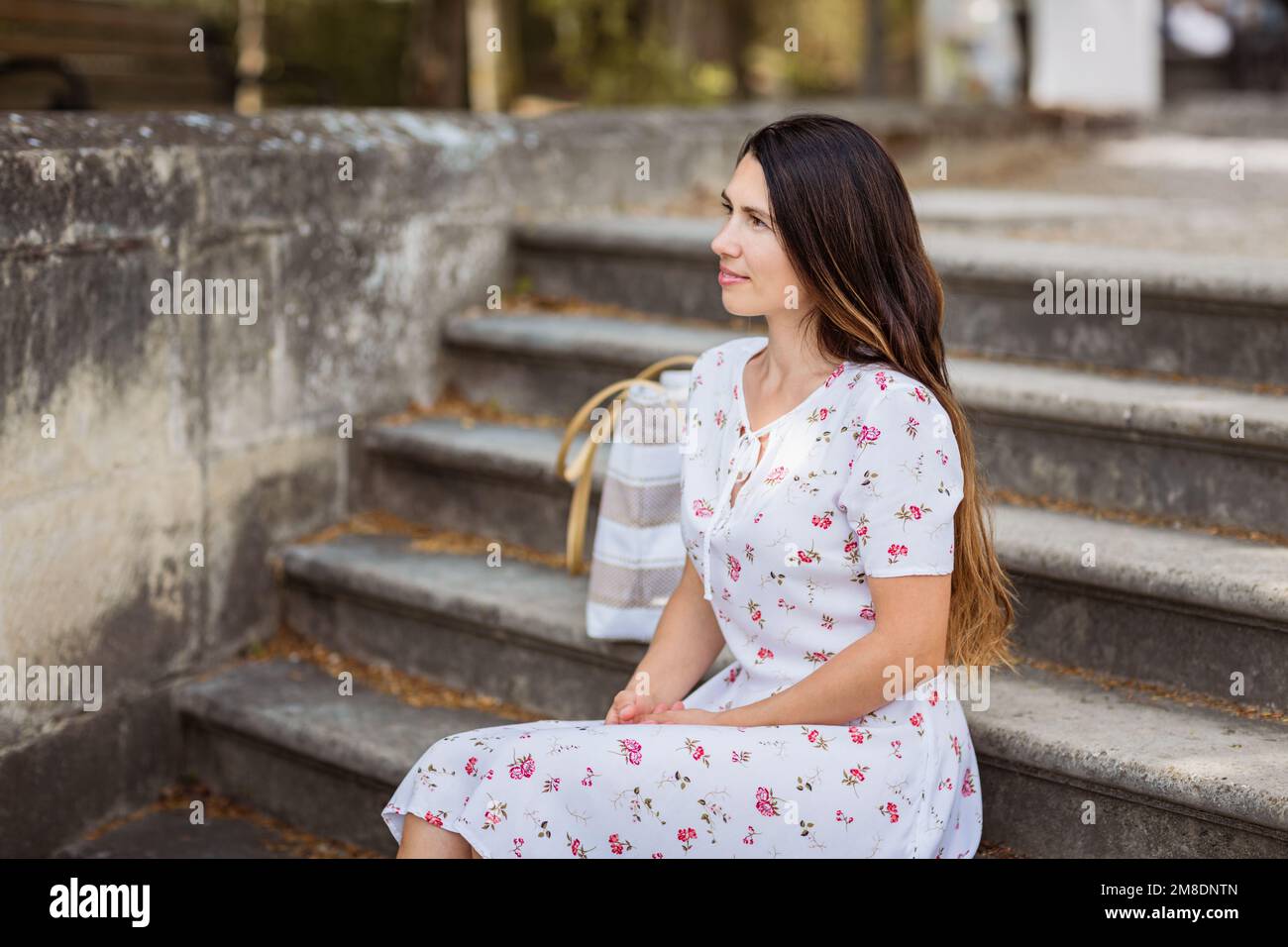 Pretty woman sitting and posing on ancient stone stairs Stock Photo - Alamy