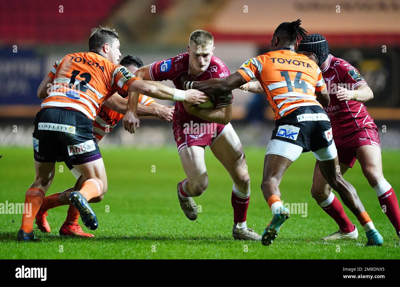 Scarlets' Johnny McNicholl is tackled by Toyota Cheetahs' Reinhardt ...