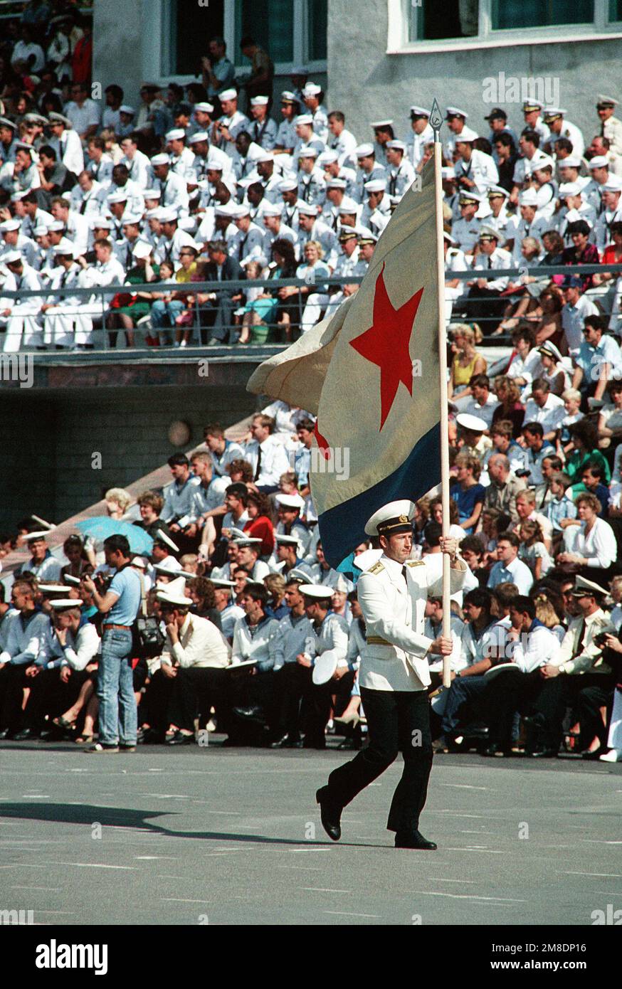 An officer carries the Soviet naval ensign at the start of a military ...