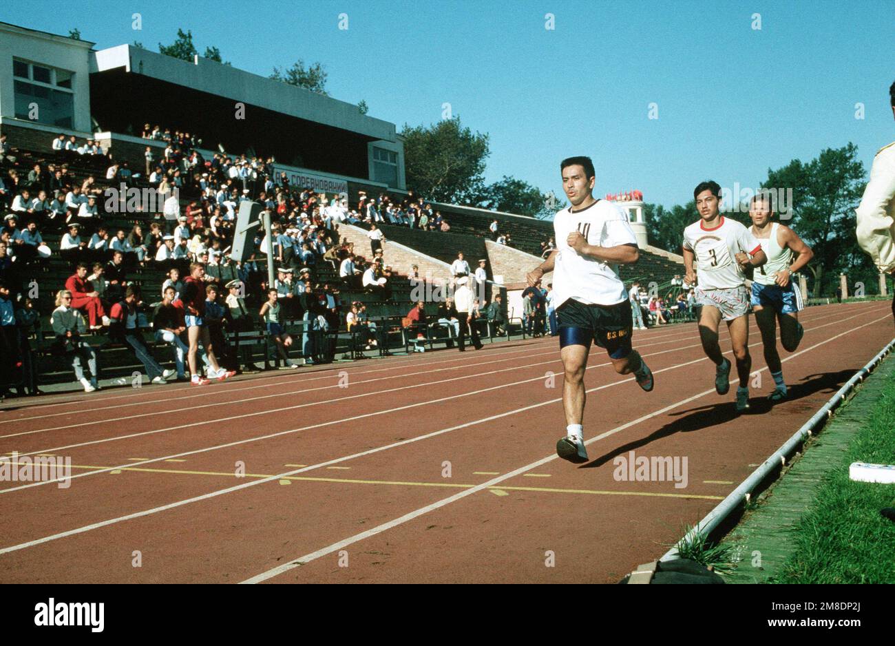 American and Soviet sailors run in a track meet during a goodwill visit ...