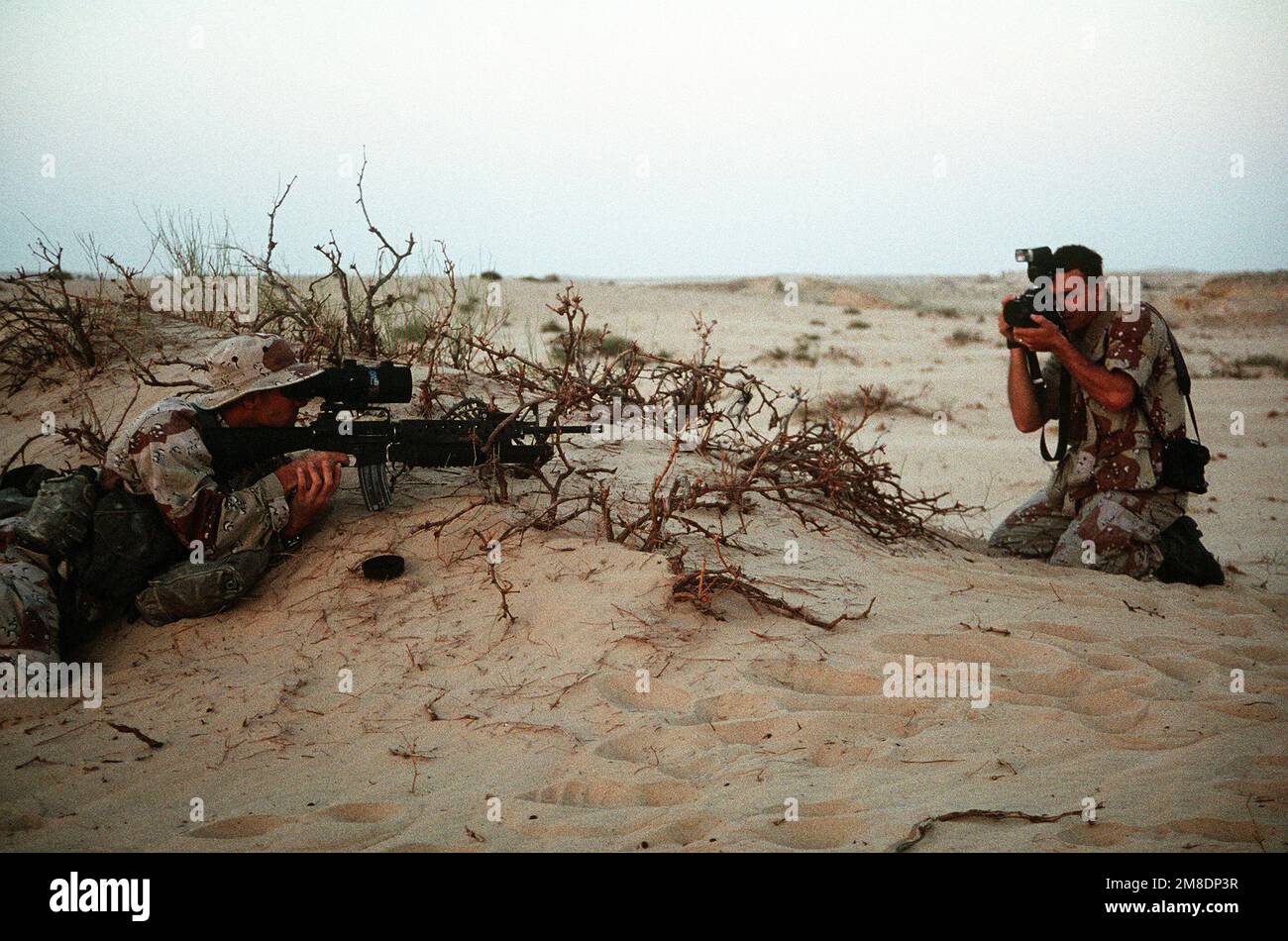 Photographer's Mate 1ST Class Scott Allen photographs a sniper of the ...