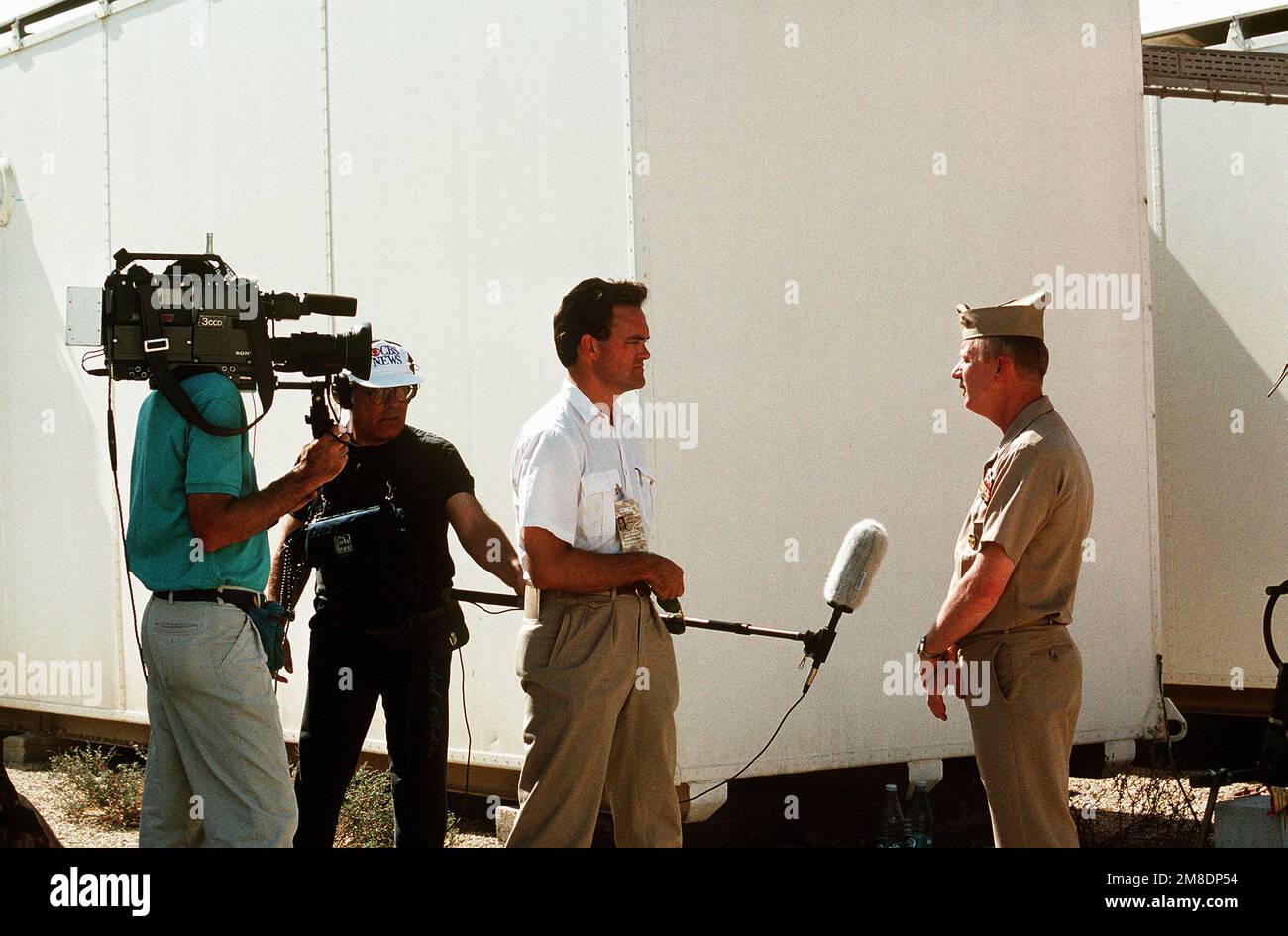 A team from CBS interviews a member of the Navy Broadcasting Service at ...