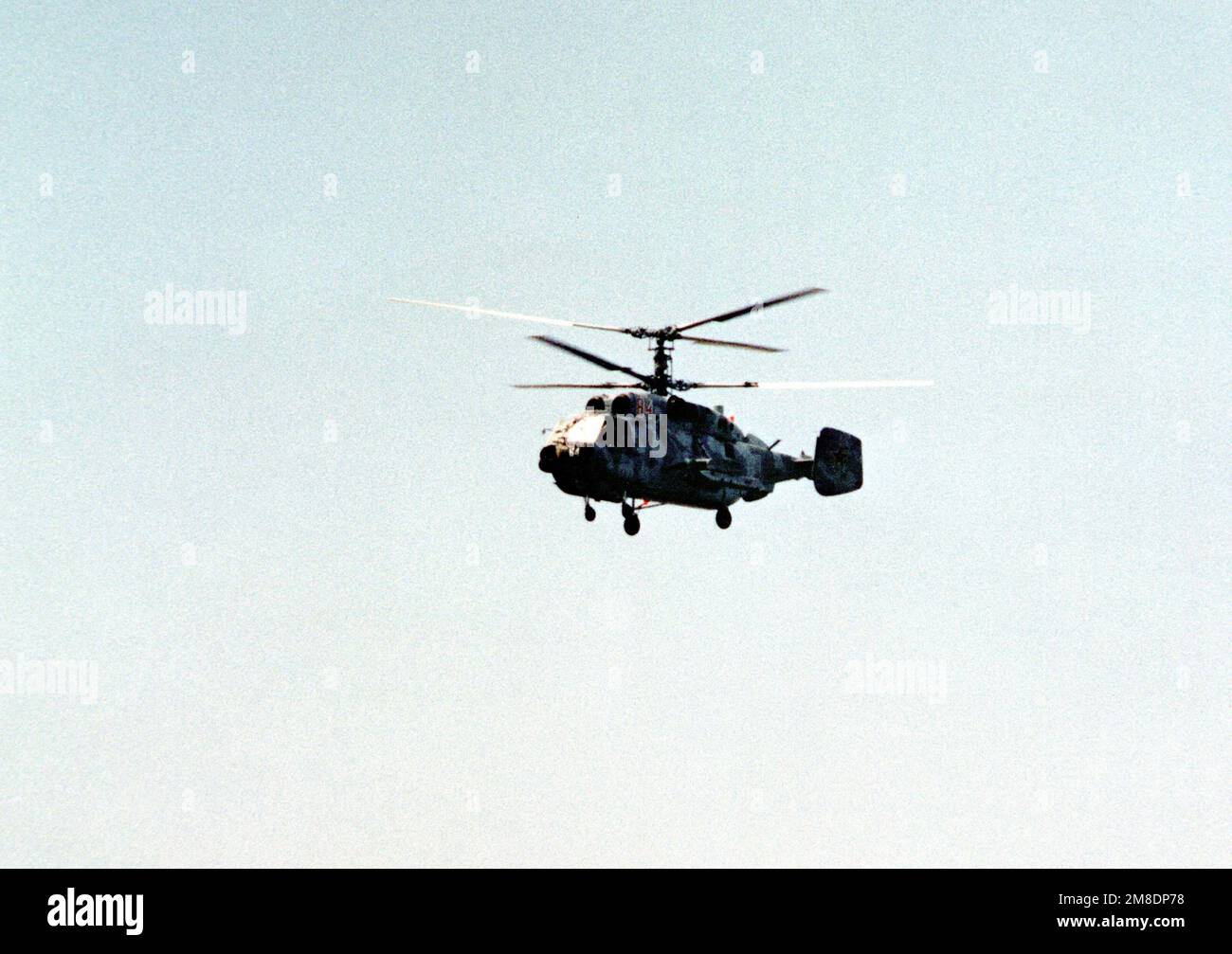 A left side view of a Soviet Ka-29 Helix B helicopter in flight during ...