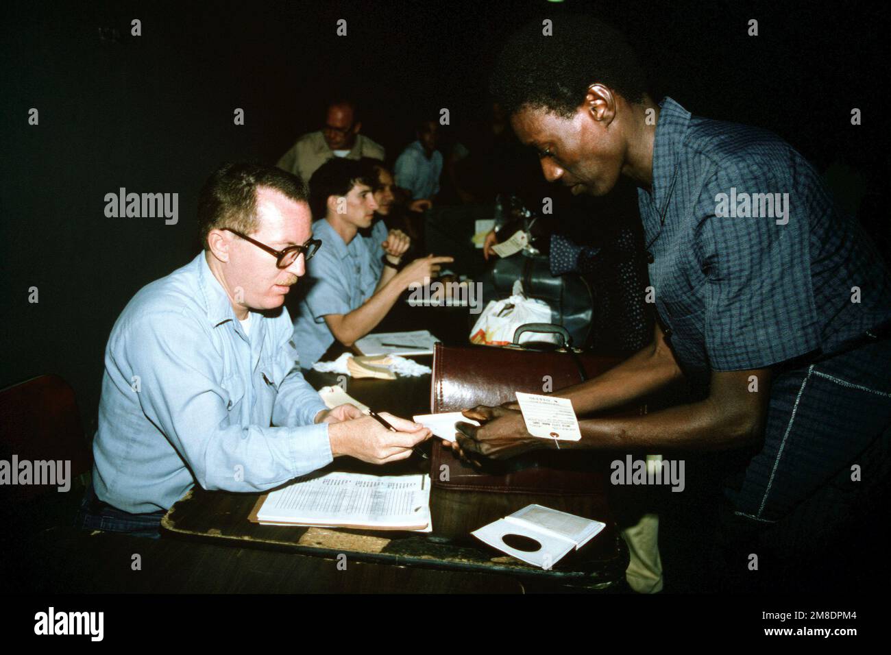 A woman provides identification to a petty officer aboard the tank ...