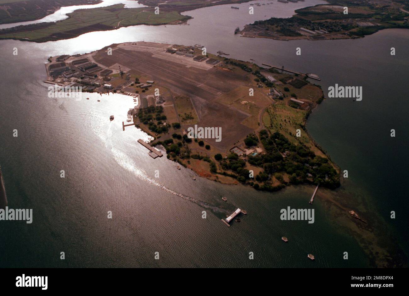 An aerial view of Ford Island and the USS ARIZONA Memorial. Base: Pearl ...