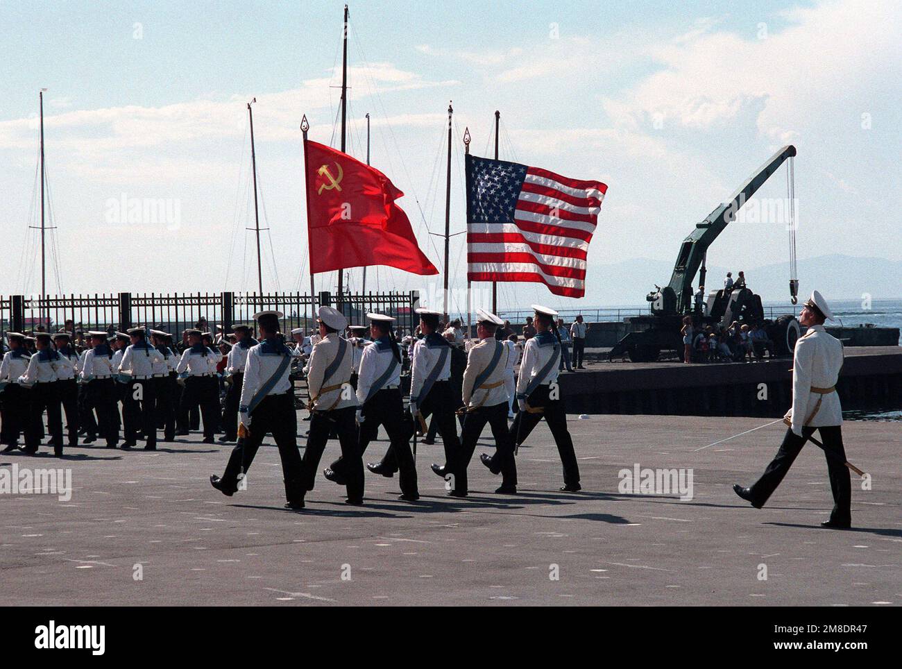 A Soviet navy color guard parades the Soviet and US flags at a review ...