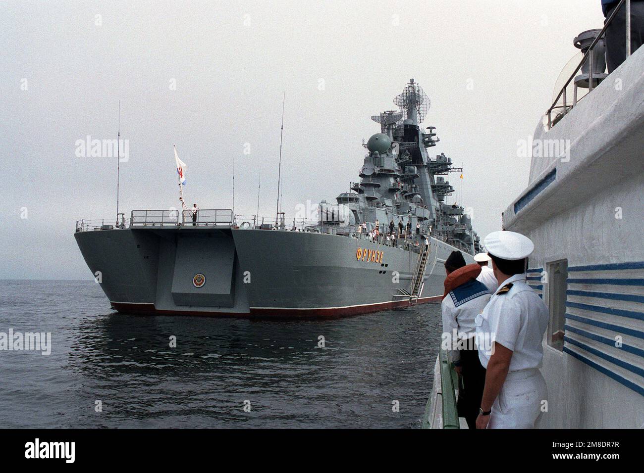 An American officer aboard a barge watches as the craft approaches the ...
