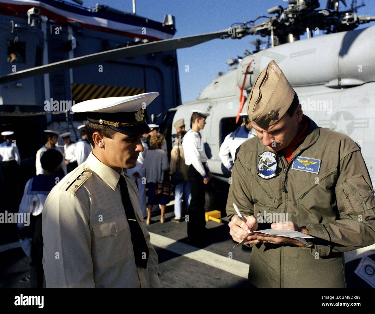 A pilot from Light Helicopter Anti-submarine Squadron 47 (HSL-47) signs ...