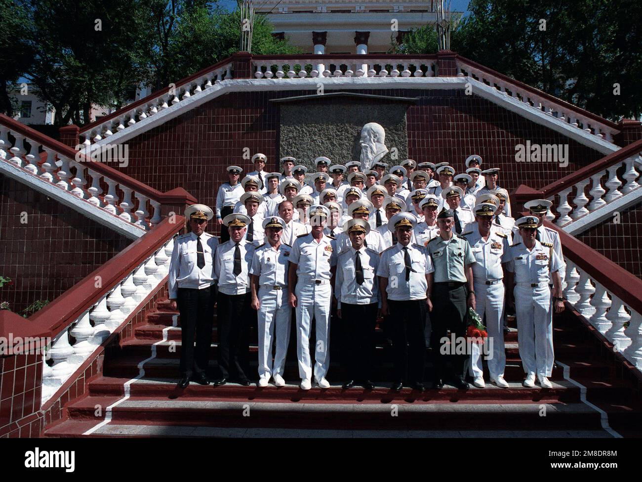 Americans and their Soviet hosts gather in front of a Soviet navy ...