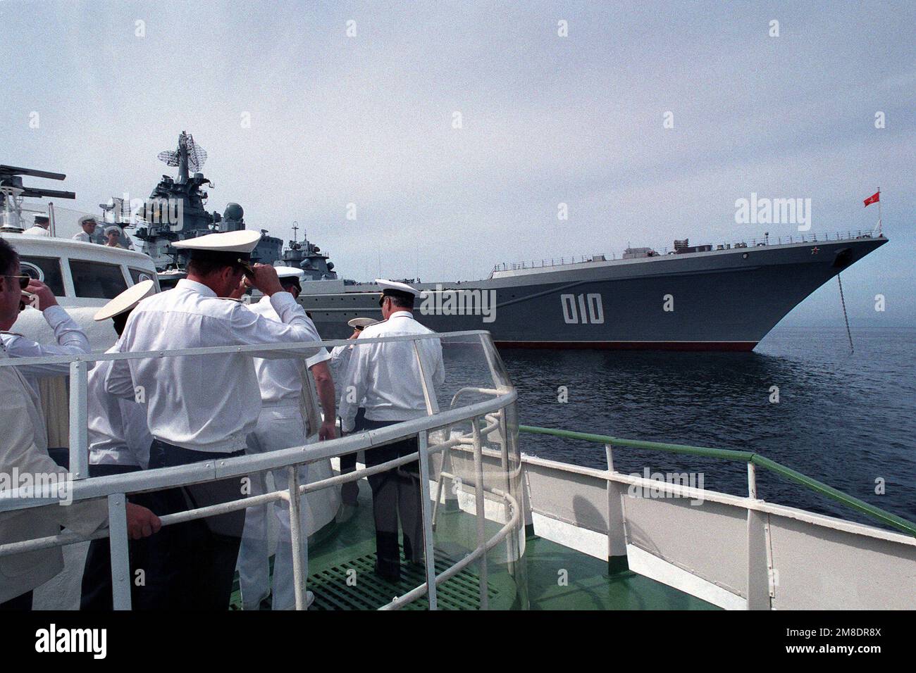 US and Soviet navy personnel stand by as the barge they are riding ...