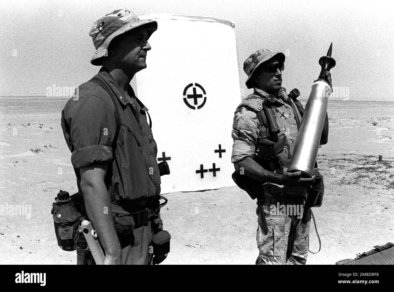 A Marine from the 3rd Tank Battalion holds up a 105mm round for an M ...
