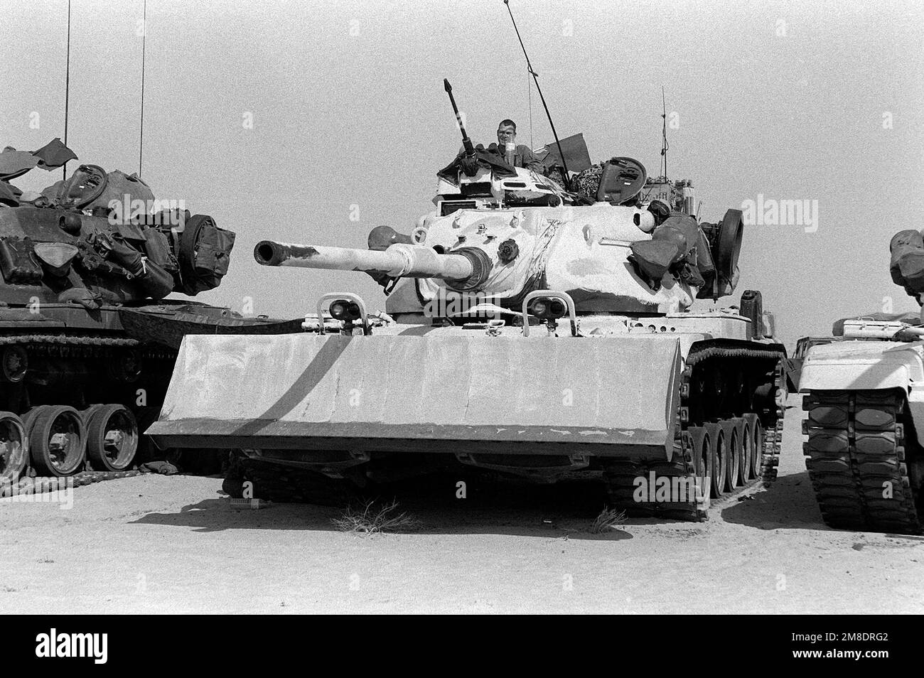 A Marine from the 1ST Tank Battalion stands in the commander's cupola ...