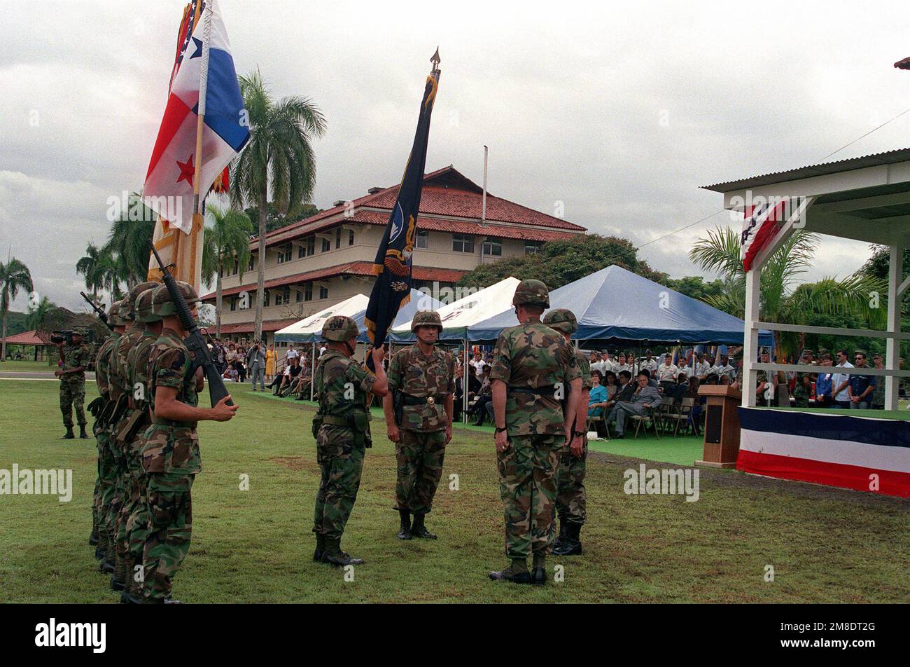 Command SGT. MAJ. Arthur F. Garcia presents the post's colors during a ...