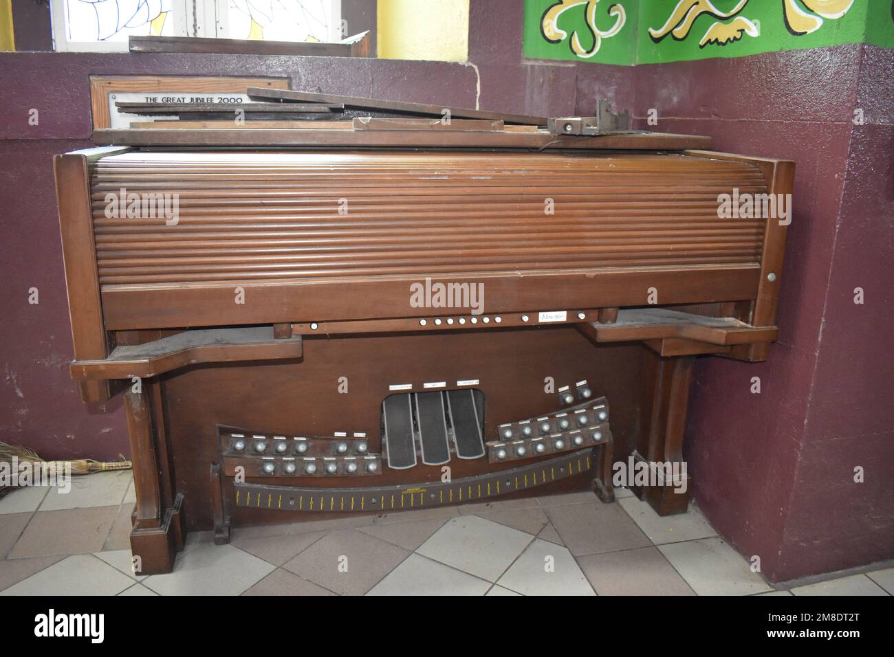 The console of a pipe organ, with pistons and combination action ...