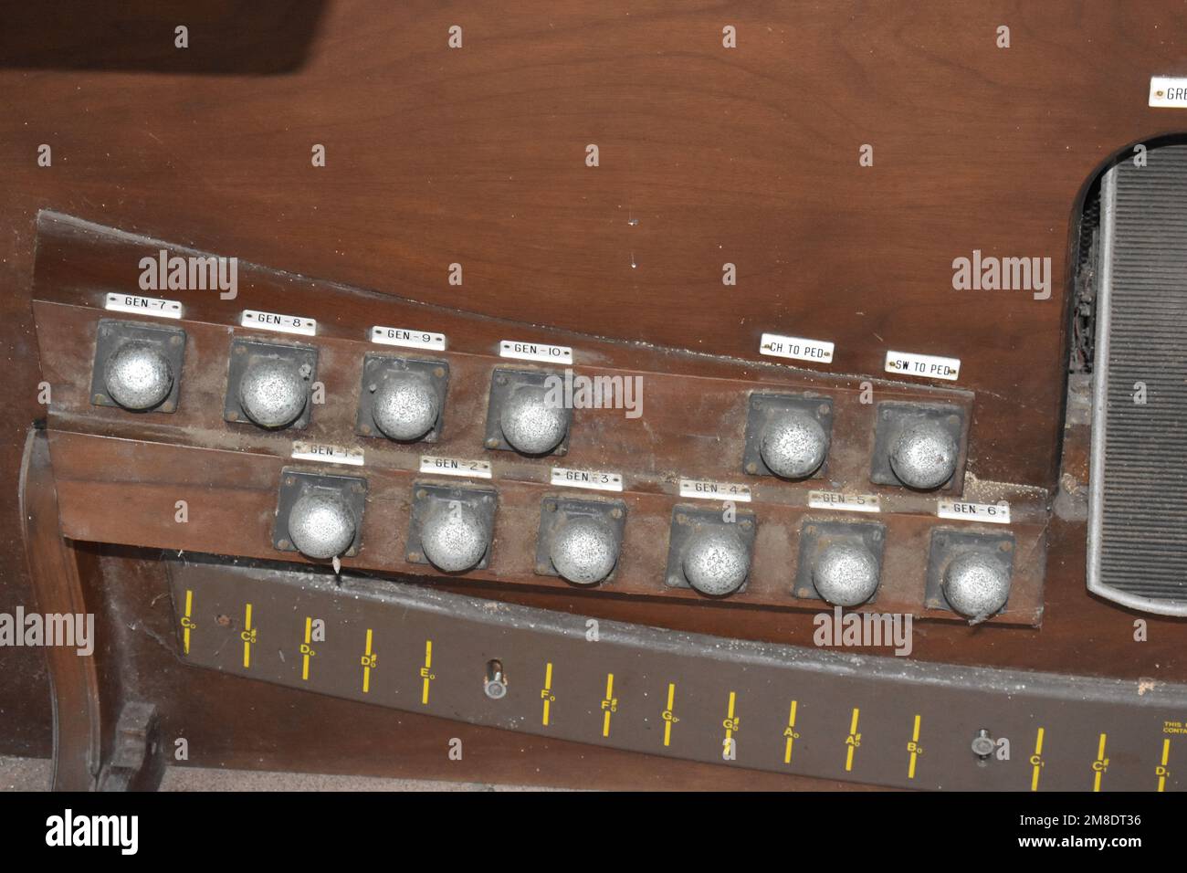 The console of a pipe organ, with pistons and combination action ...