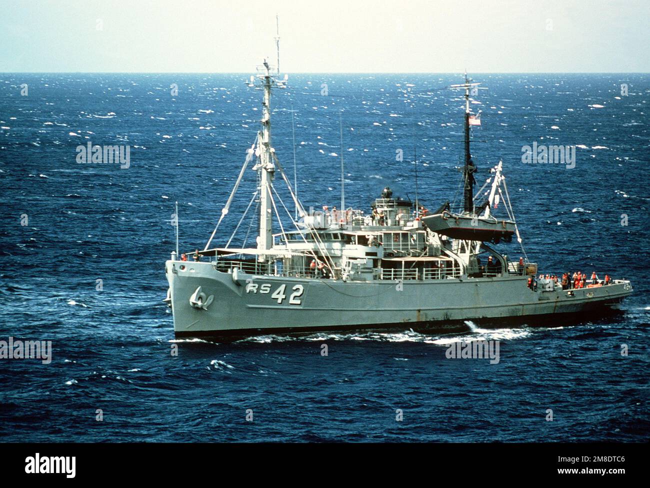 A port view of the salvage ship USS RECLAIMER (ARS-42) underway near ...