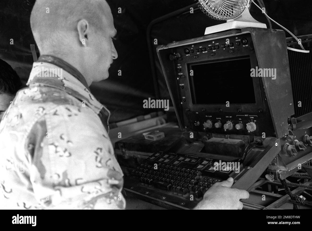A Marine from Btry. I, 3rd Bn., 11th Marines, works at a fire control ...