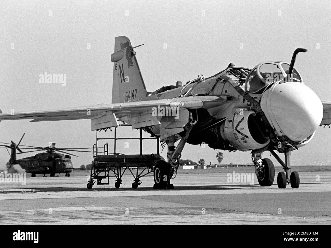 With a lifting harness secured around its fuselage, a damaged Attack ...