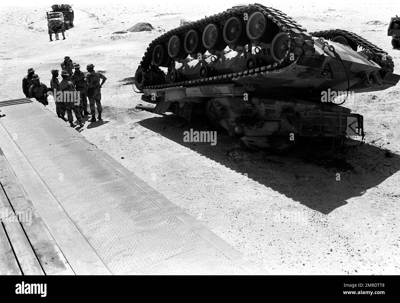Members of the 3rd Tank Battalion, 1ST Marine Division, stand near a B ...