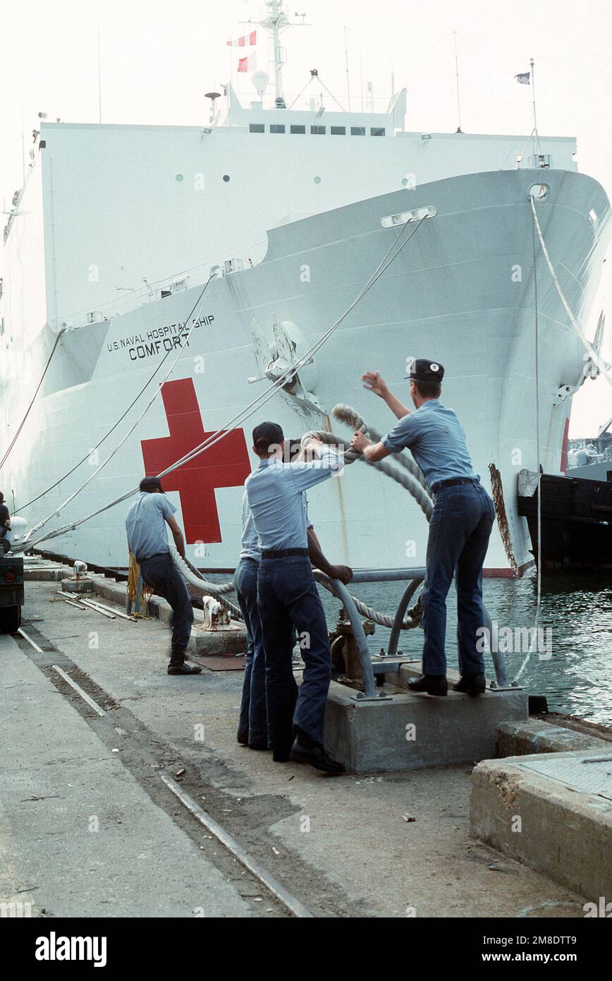 Sailors cast off mooring lines as the hospital ship USNS COMFORT (T-AH ...