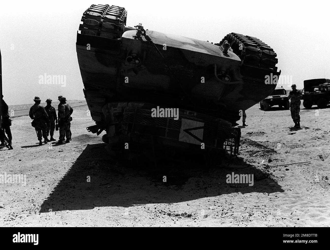 Members of the 3rd Tank Battalion, 1ST Marine Division, stand near a B ...