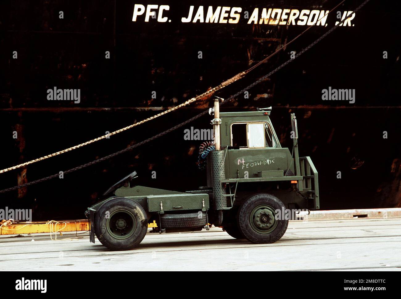 An M-878 tractor truck sits on the pier before being loaded aboard the ...