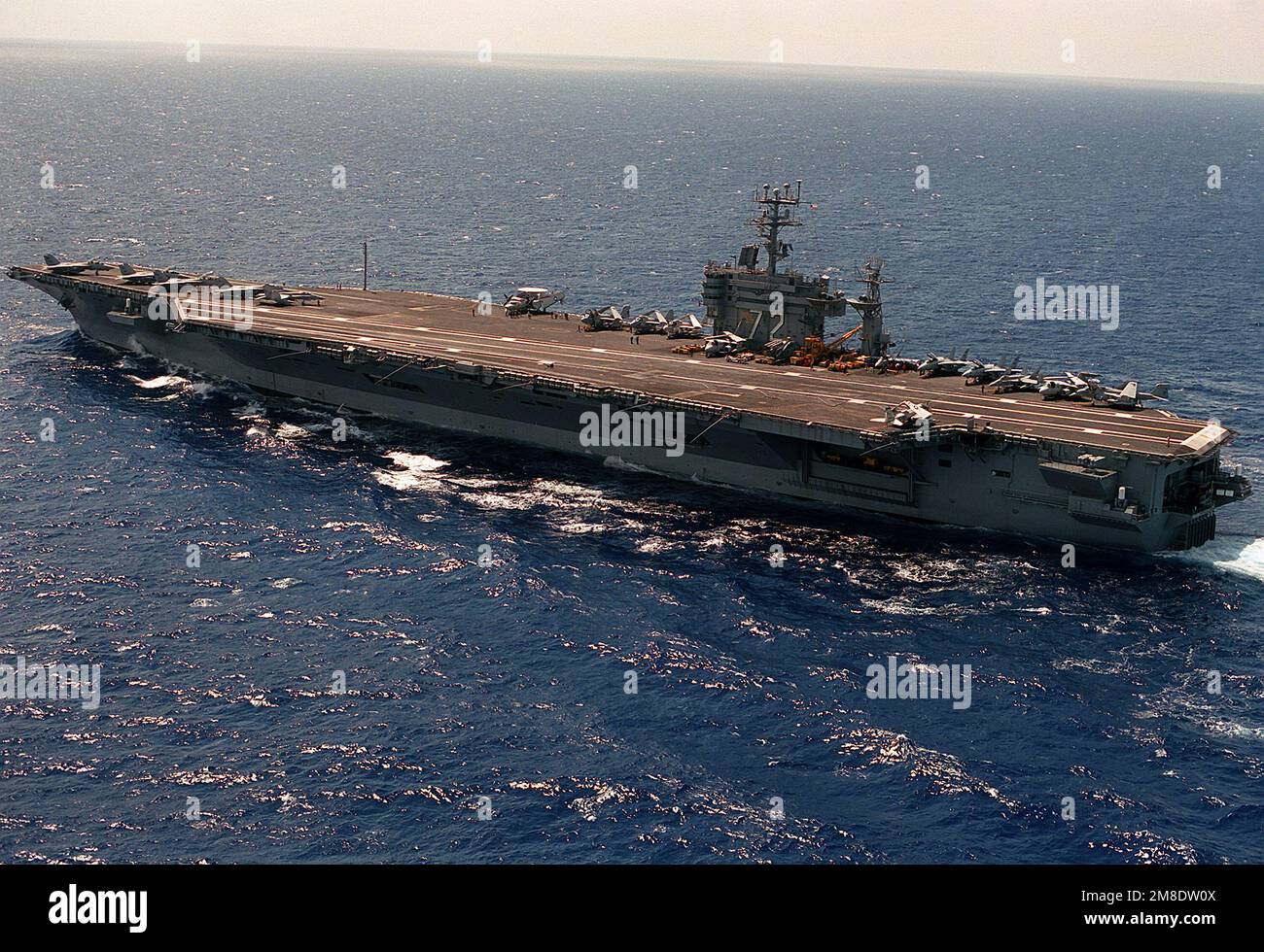 A port view of the nuclear-powered aircraft carrier USS ABRAHAM LINCOLN ...