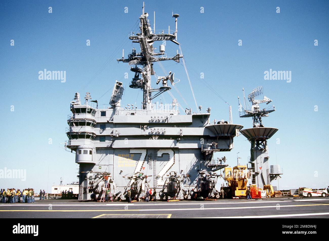 Maintenance crew members work on Helicopter Anti-submarine Squadron 17 ...