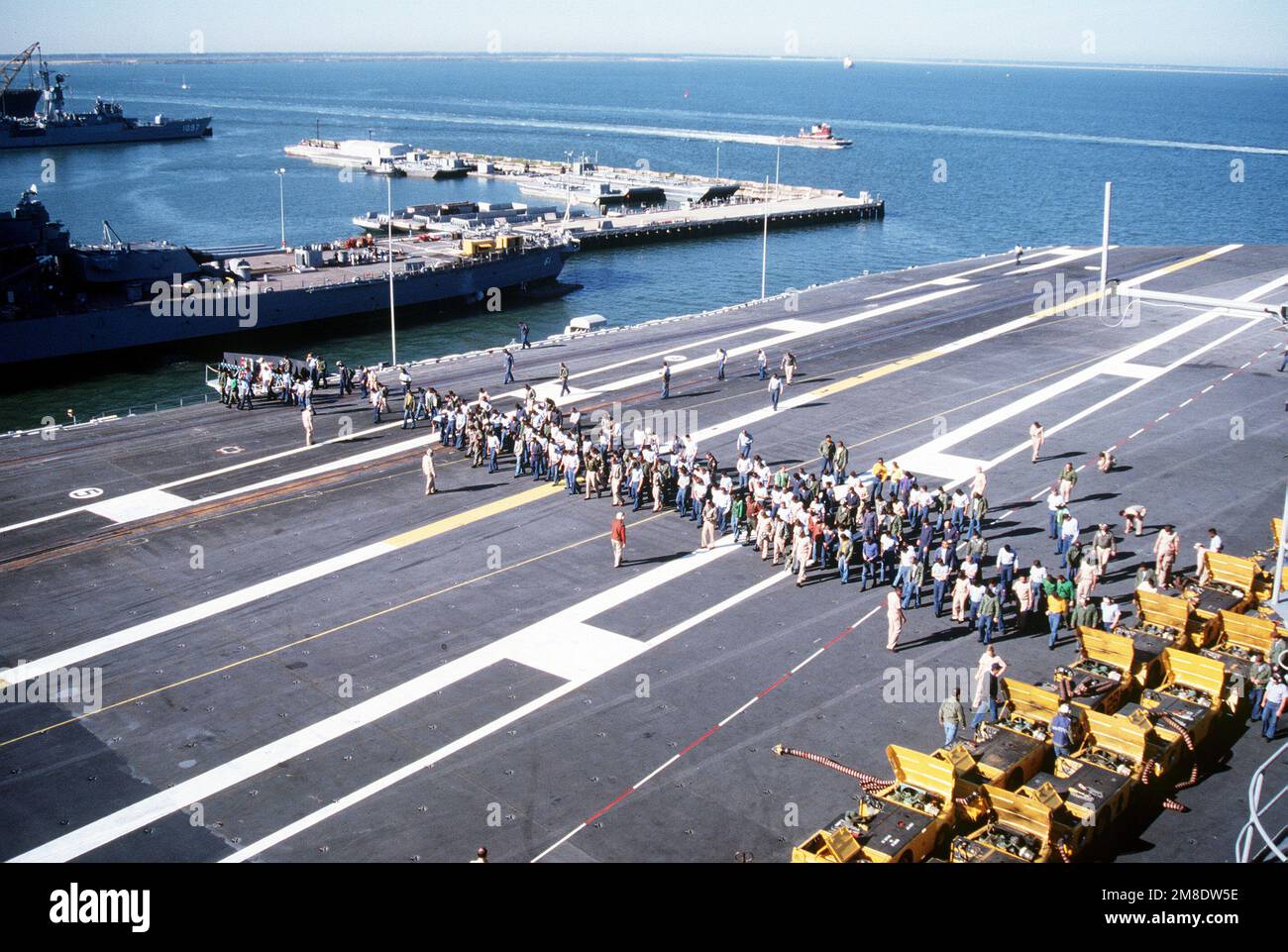 Crew members conduct a foreign object damage (FOD) walk-down on the ...