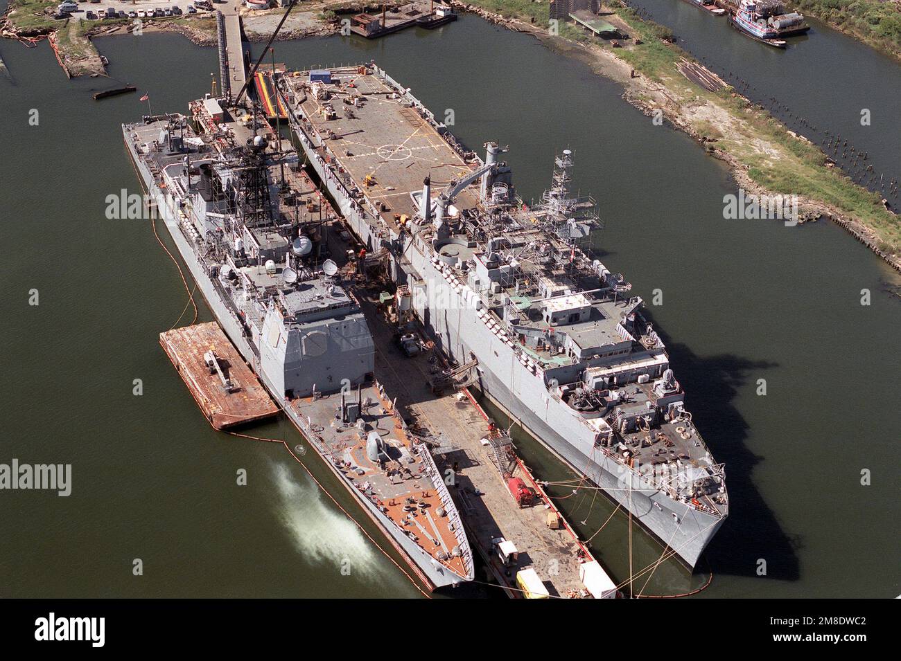 An aerial view of the guided missile cruiser USS YORKTOWN (CG-48), left ...