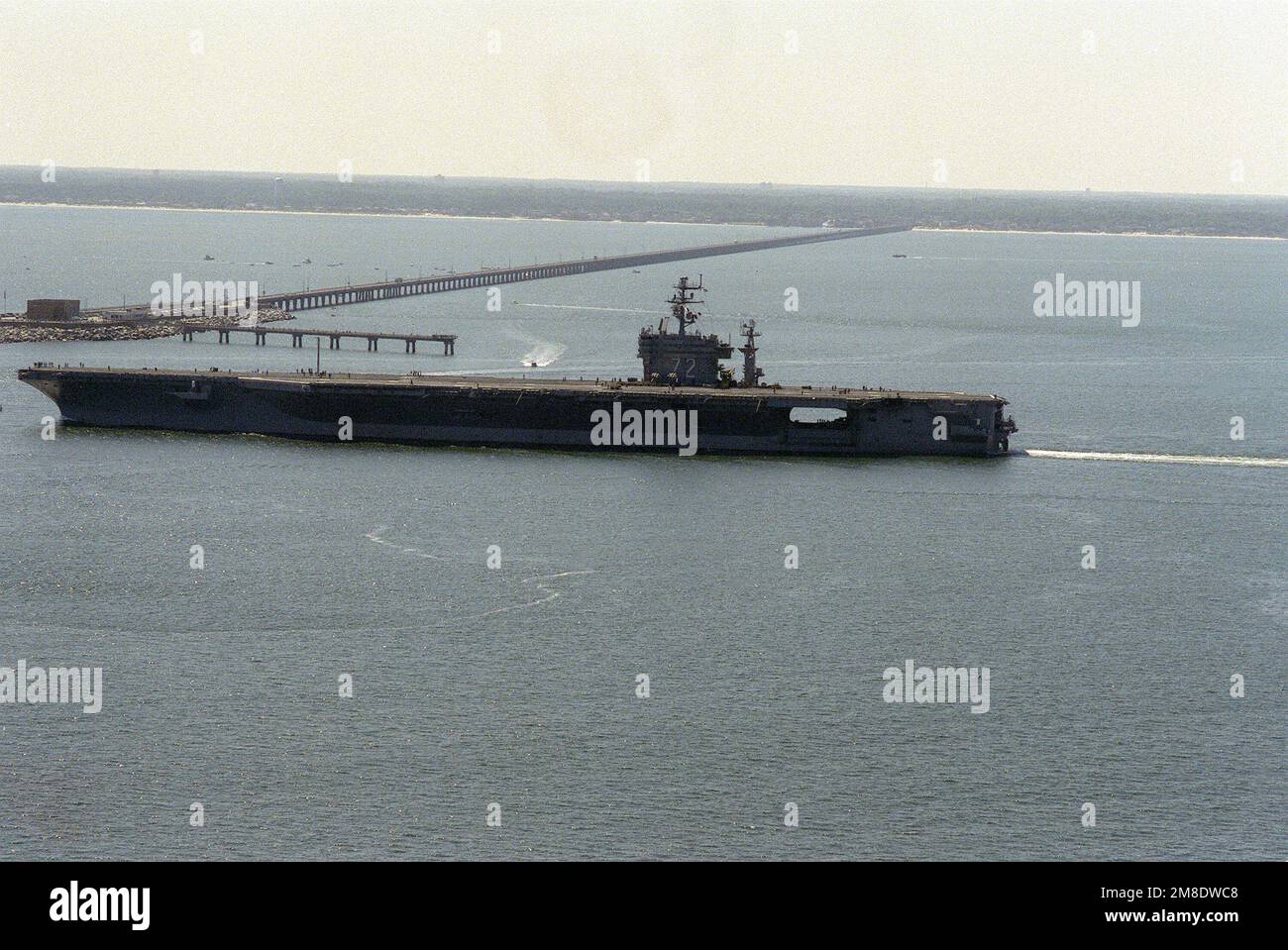 A port beam view of the nuclear-powered aircraft carrier USS ABRAHAM ...