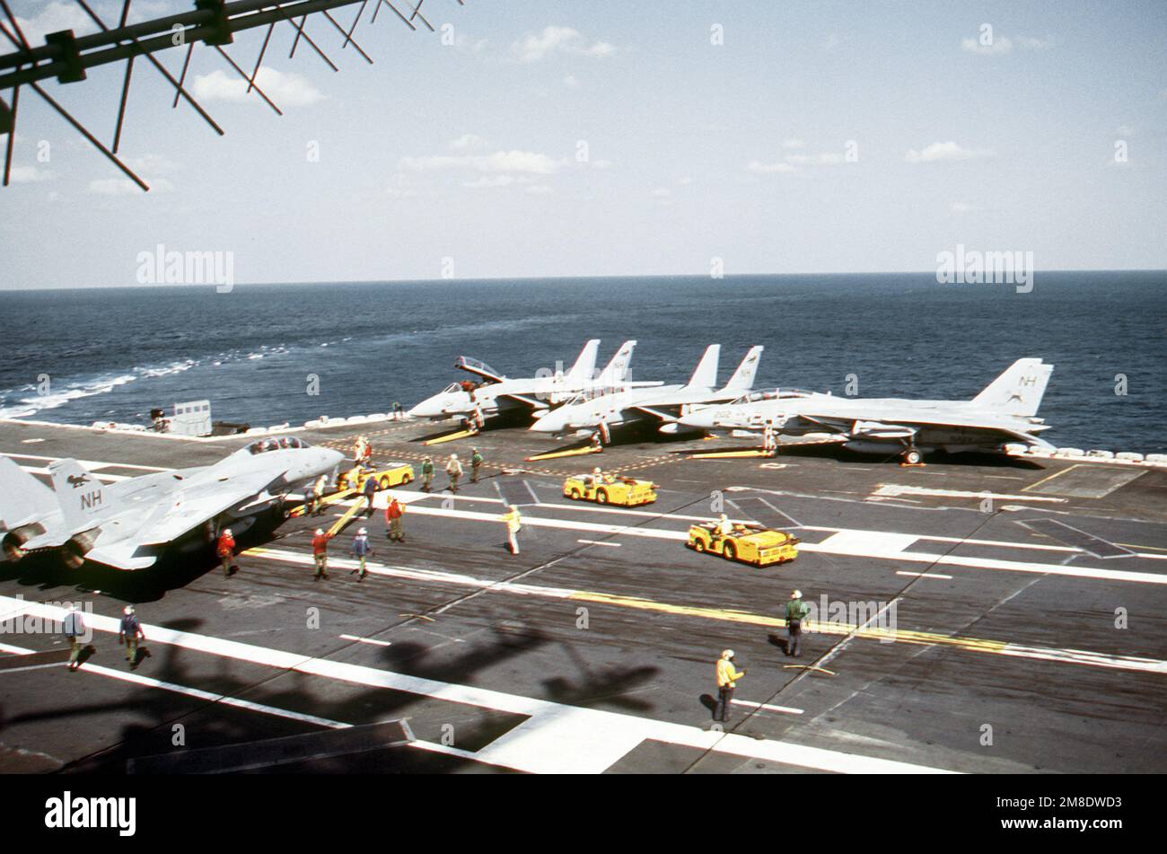 Flight deck crewmen respot a Fighter Squadron 114 (VF-114) F-14A Tomcat ...