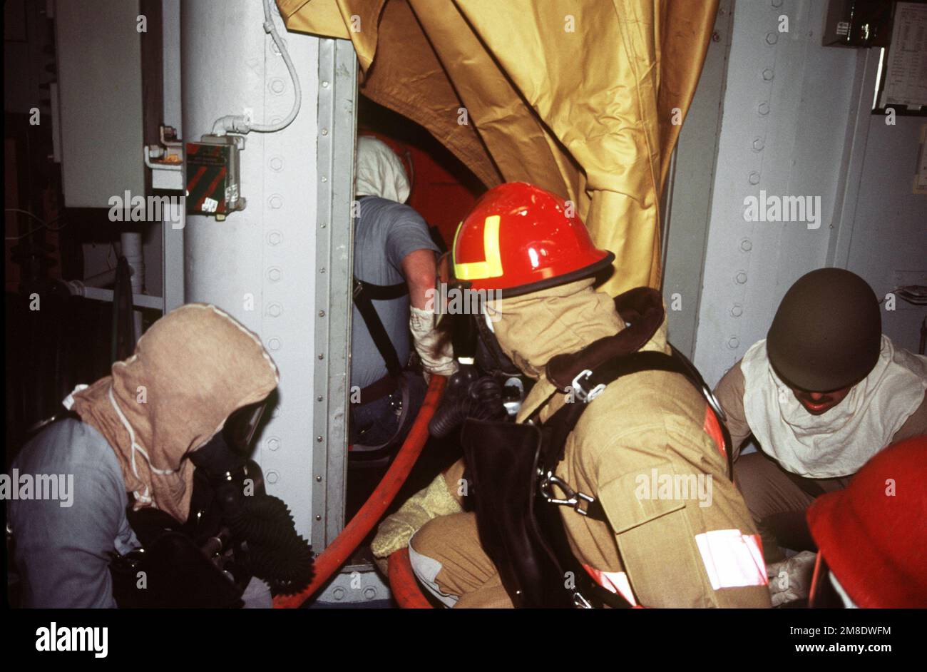 Keeping low to minimize exposure to the heat, members of a repair party ...